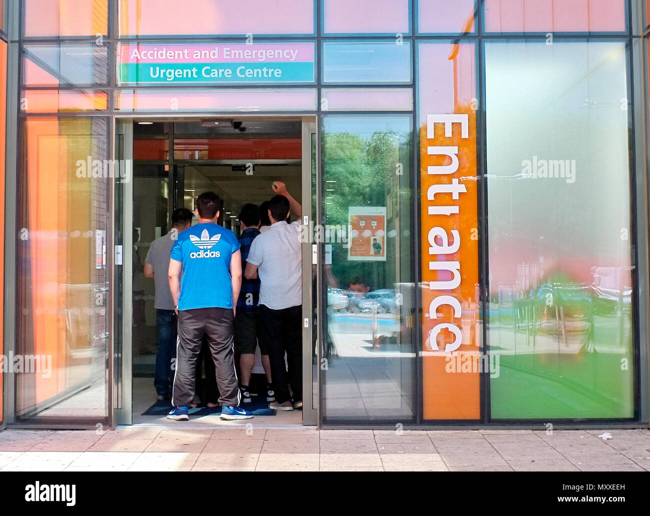 A long queue at an NHS accident and emergency centre building entrance ...