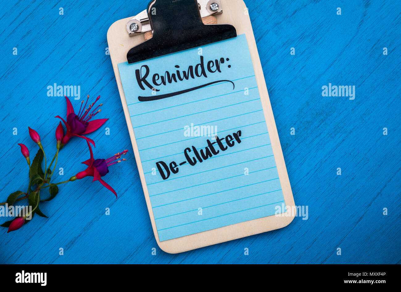 Reminder to De-Clutter still life motivational concept on clipboard and ...