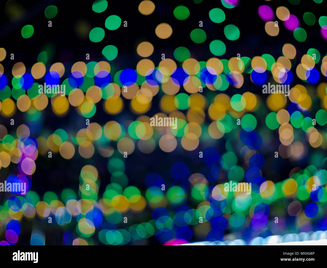Abstract image of unfocused multicolored lights shining in the night ...