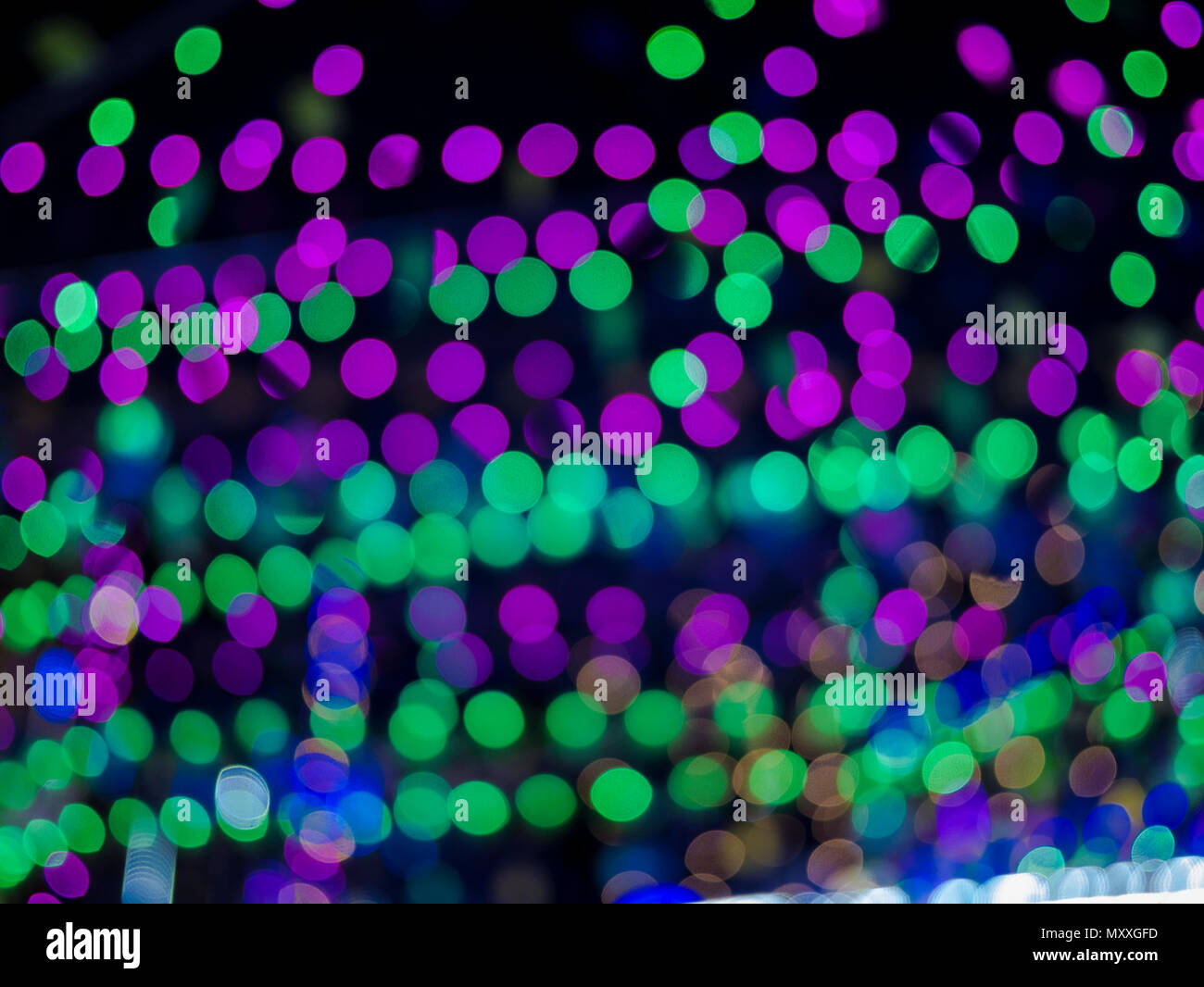 Abstract image of unfocused multicolored lights shining in the night ...