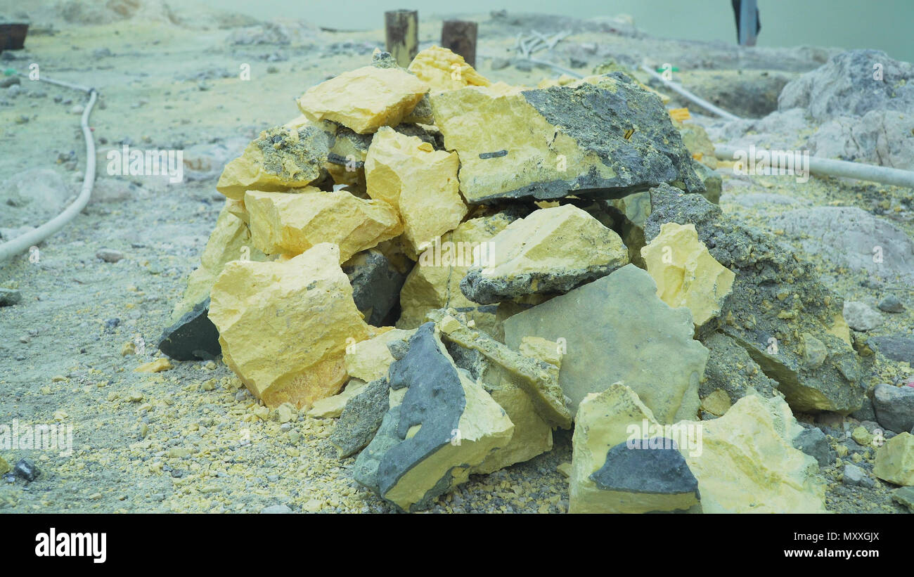 Extraction of sulfur in the crater of a volcano. Sulfur gas, smoke ...