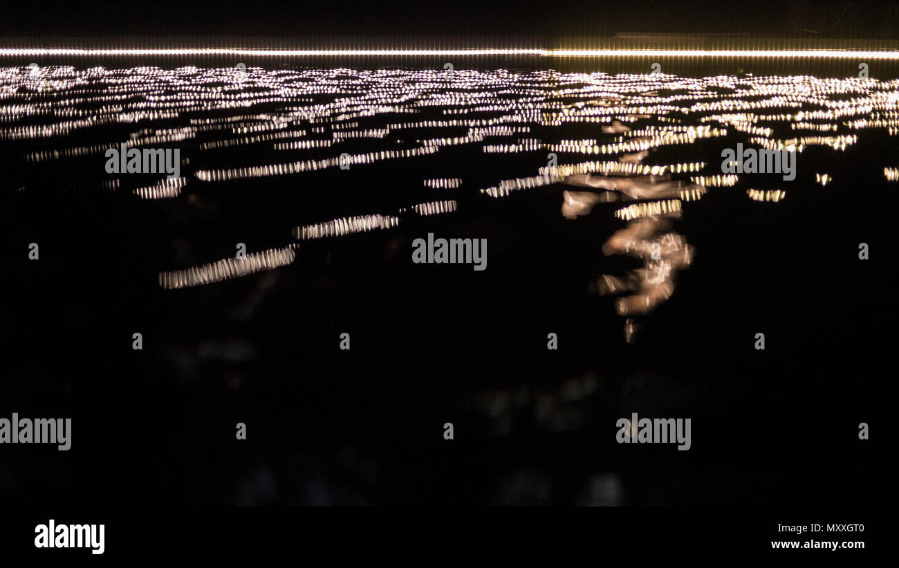 Amazing photo of yellow and white light being reflected of a dark pool ...