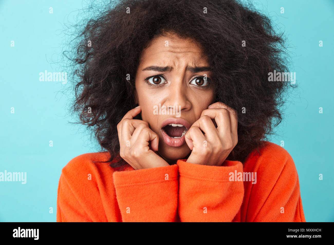 Colorful image closeup of scared woman in red shirt posing on camera ...