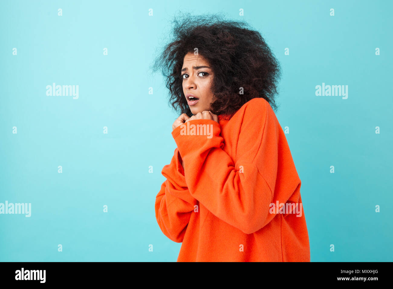 Colorful image closeup of scared woman in red shirt posing on camera ...