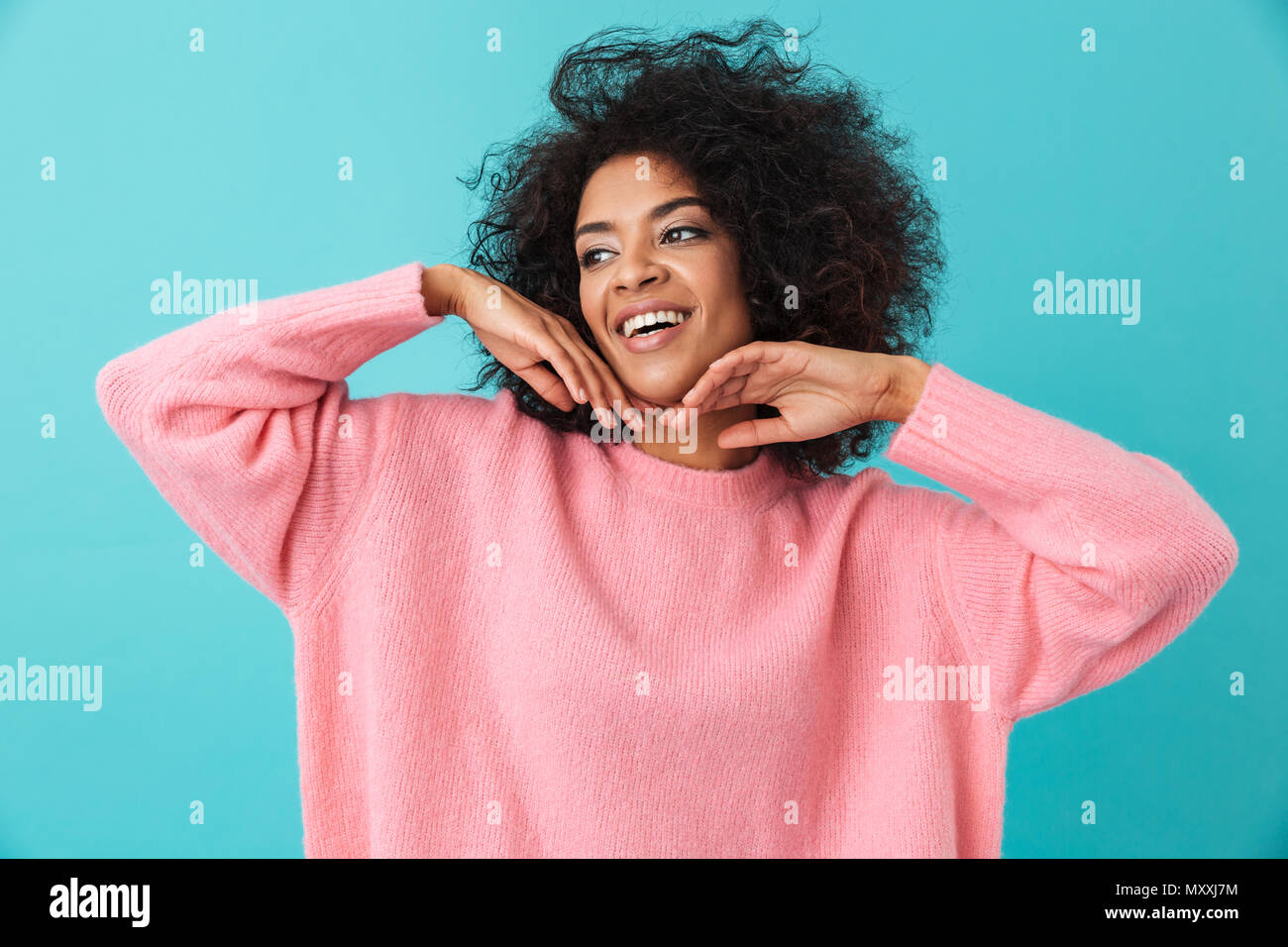 Colorful portrait of young woman 20s with afro hairstyle smiling and ...
