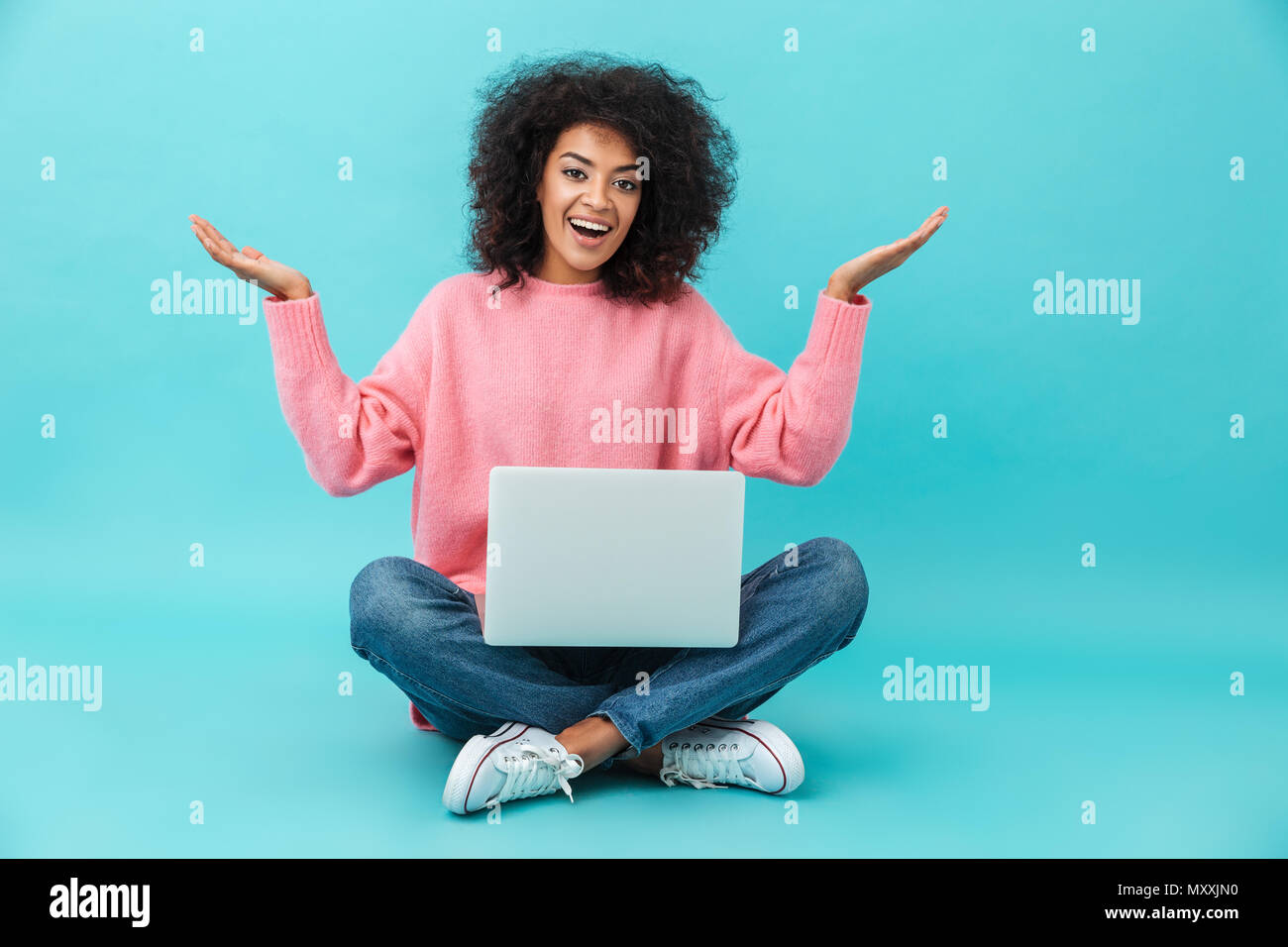 Optimistic woman with beautiful smile using silver notebook, while ...