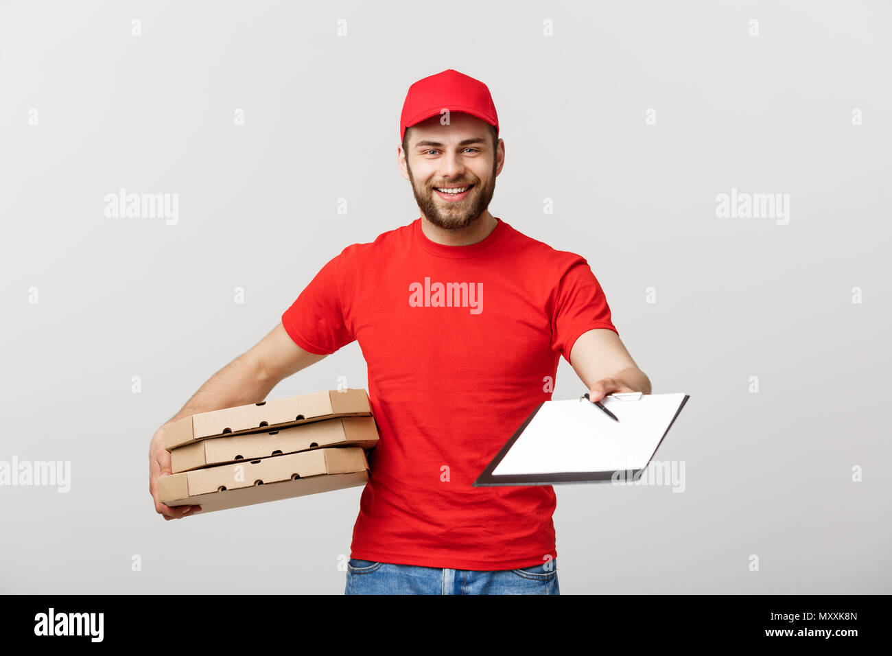 Delivery Concept: Young handsome delivery man with pizza boxes giving ...