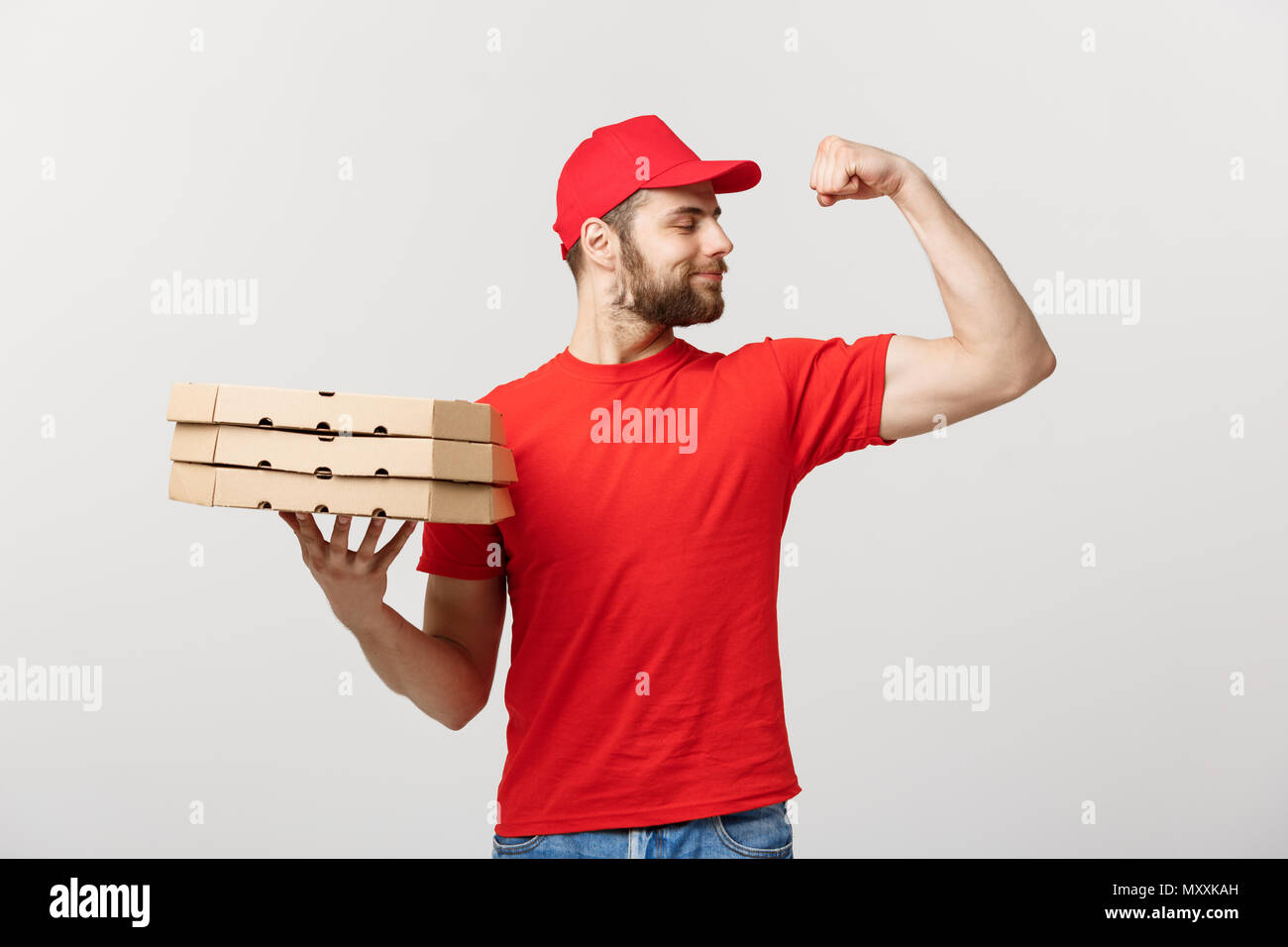 Delivery Concept - Portrait of Strong handsome delivery man flexing his ...