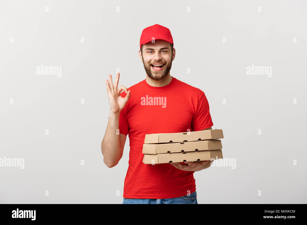 Delivery Concept: Handsome pizza delivery man making OK sign isolated ...