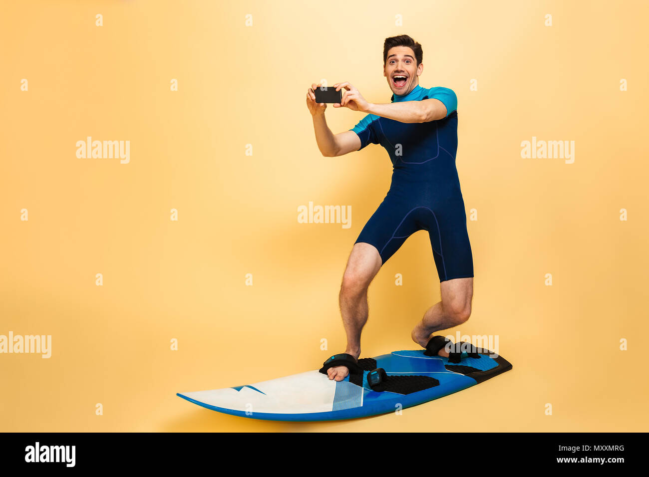 Full length portrait of an excited young man dressed in swimsuit ...