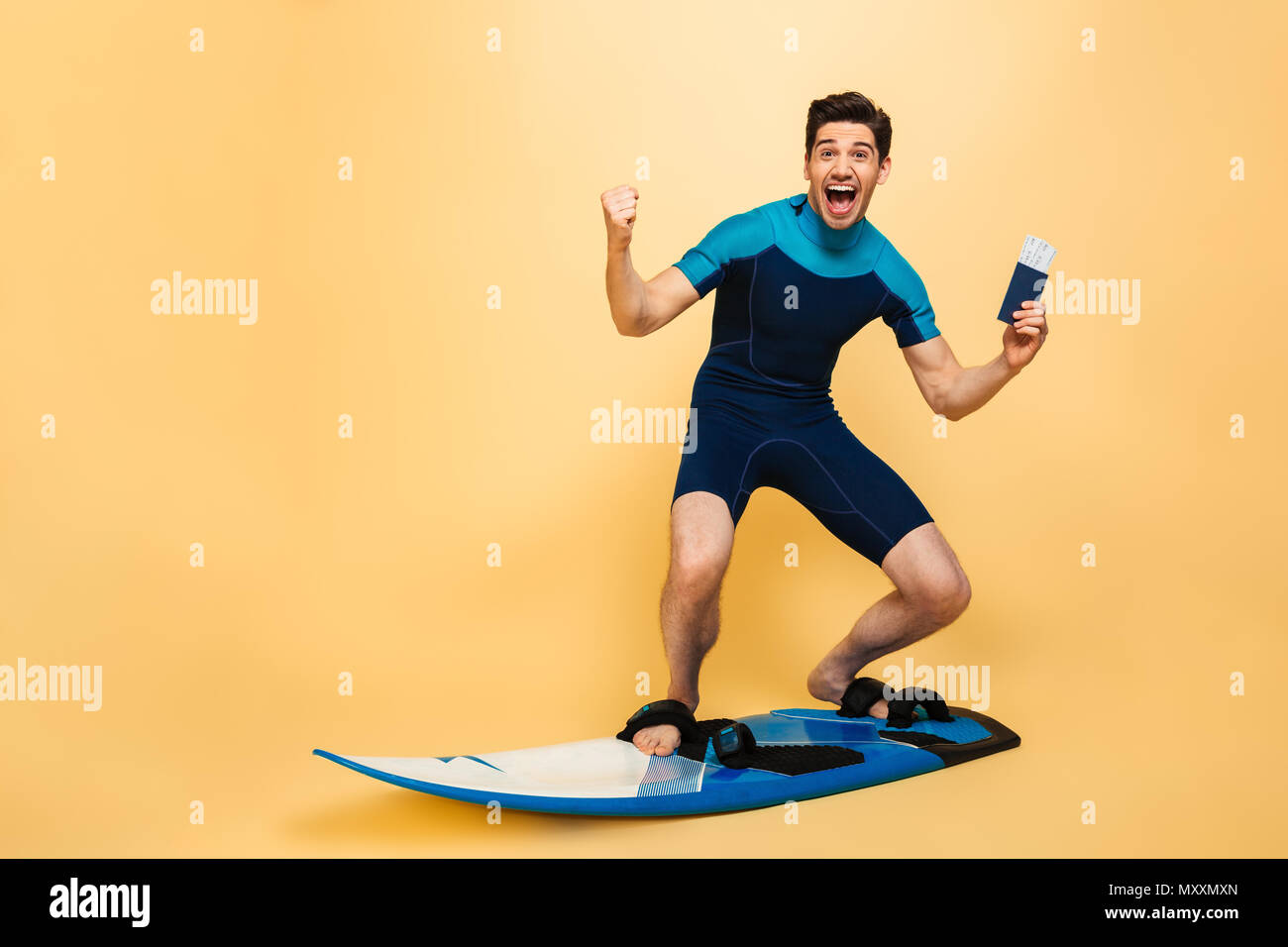 Full length portrait of a satisfied young man dressed in swimsuit ...