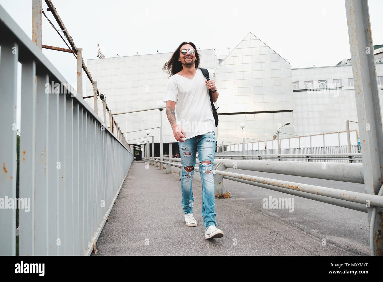 Happy man walking in the city Stock Photo - Alamy