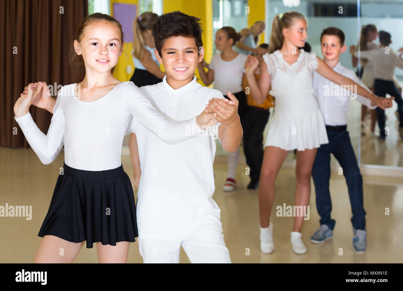 Smiling kids are dancing in pairs in class Stock Photo - Alamy