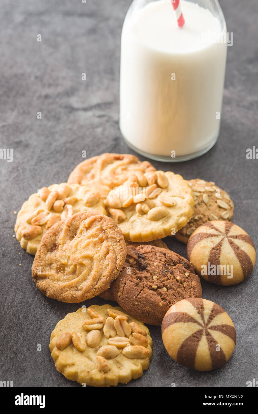 Different types of sweet cookies and bottle of milk Stock Photo - Alamy