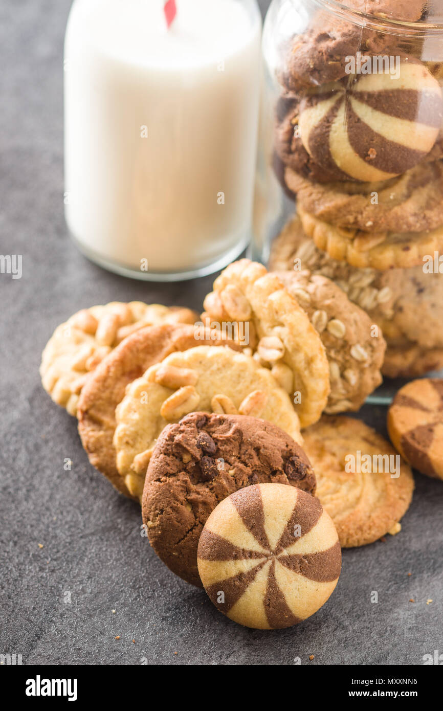 Different types of sweet cookies and bottle of milk Stock Photo - Alamy