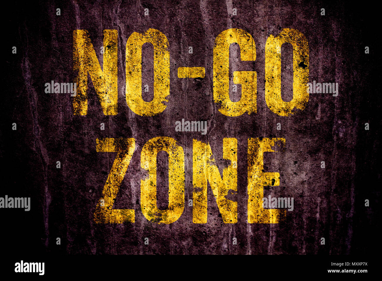 “No-Go Zone” warning sign in yellow letters painted over dark grungy ...