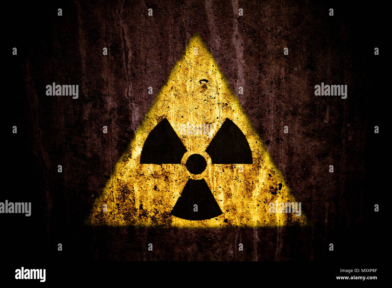 Radioactive (ionizing radiation) danger yellow symbol over a massive ...