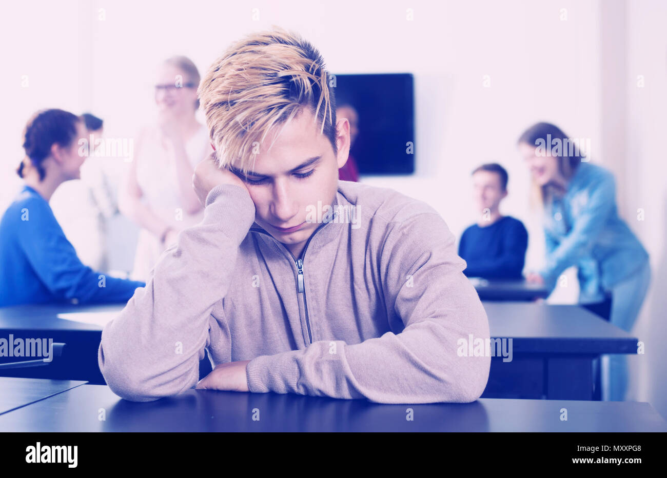 Portrait new boy student being shy among classmates at recess in school ...