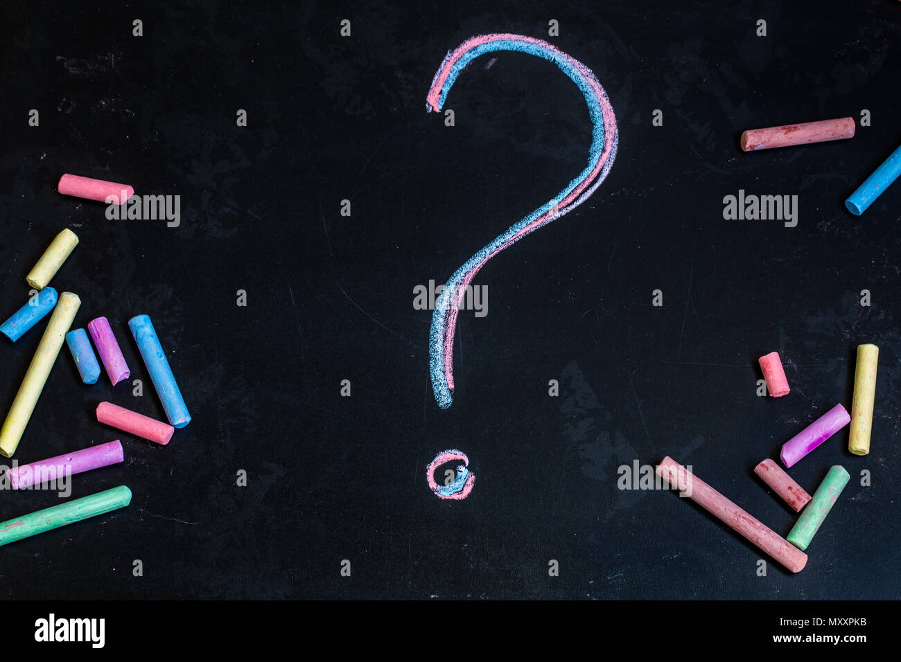 colored chalks on a black blackboard with pictures question mark Stock ...