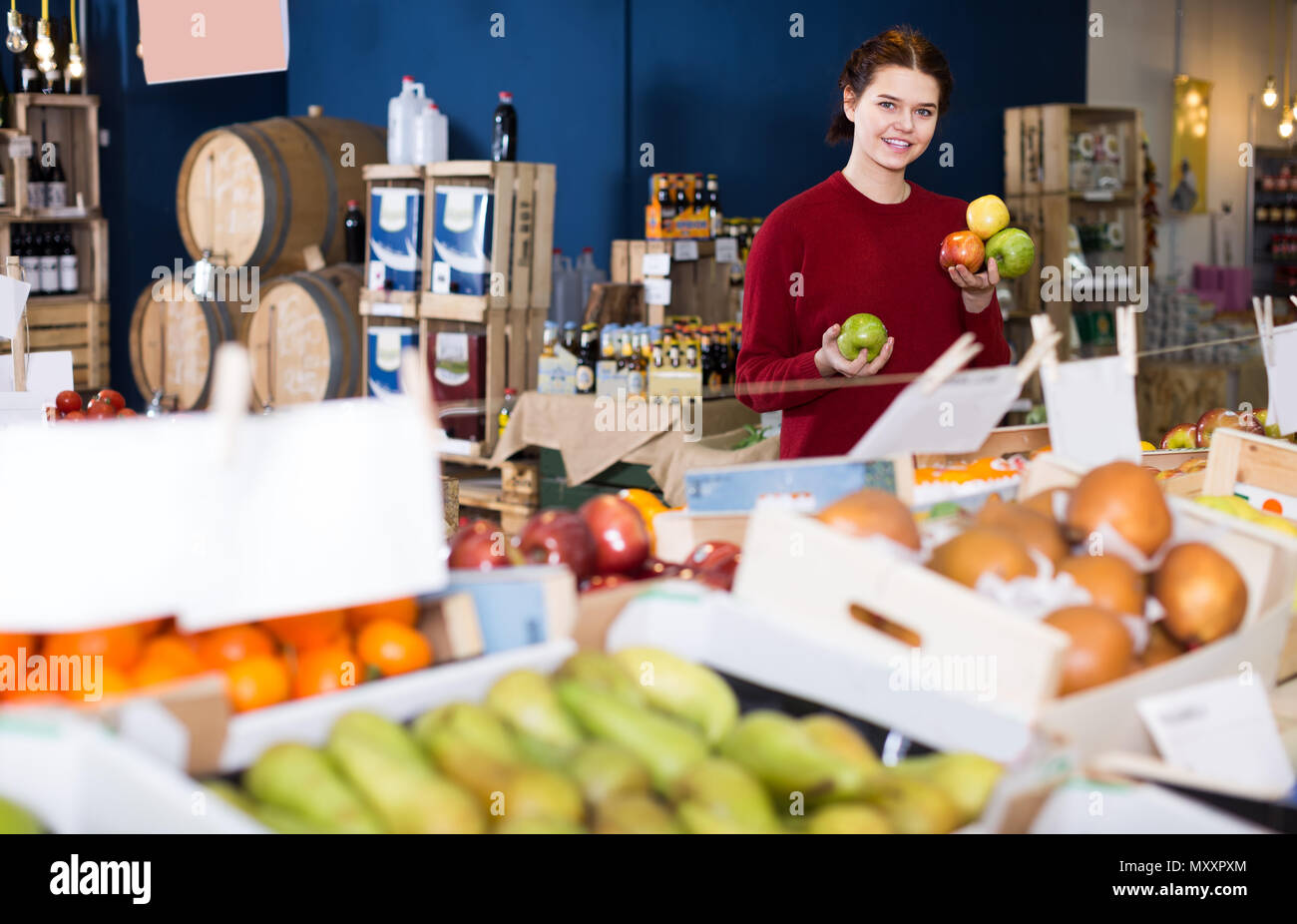 Girl customer chose different varieties of apples in the fruit ...