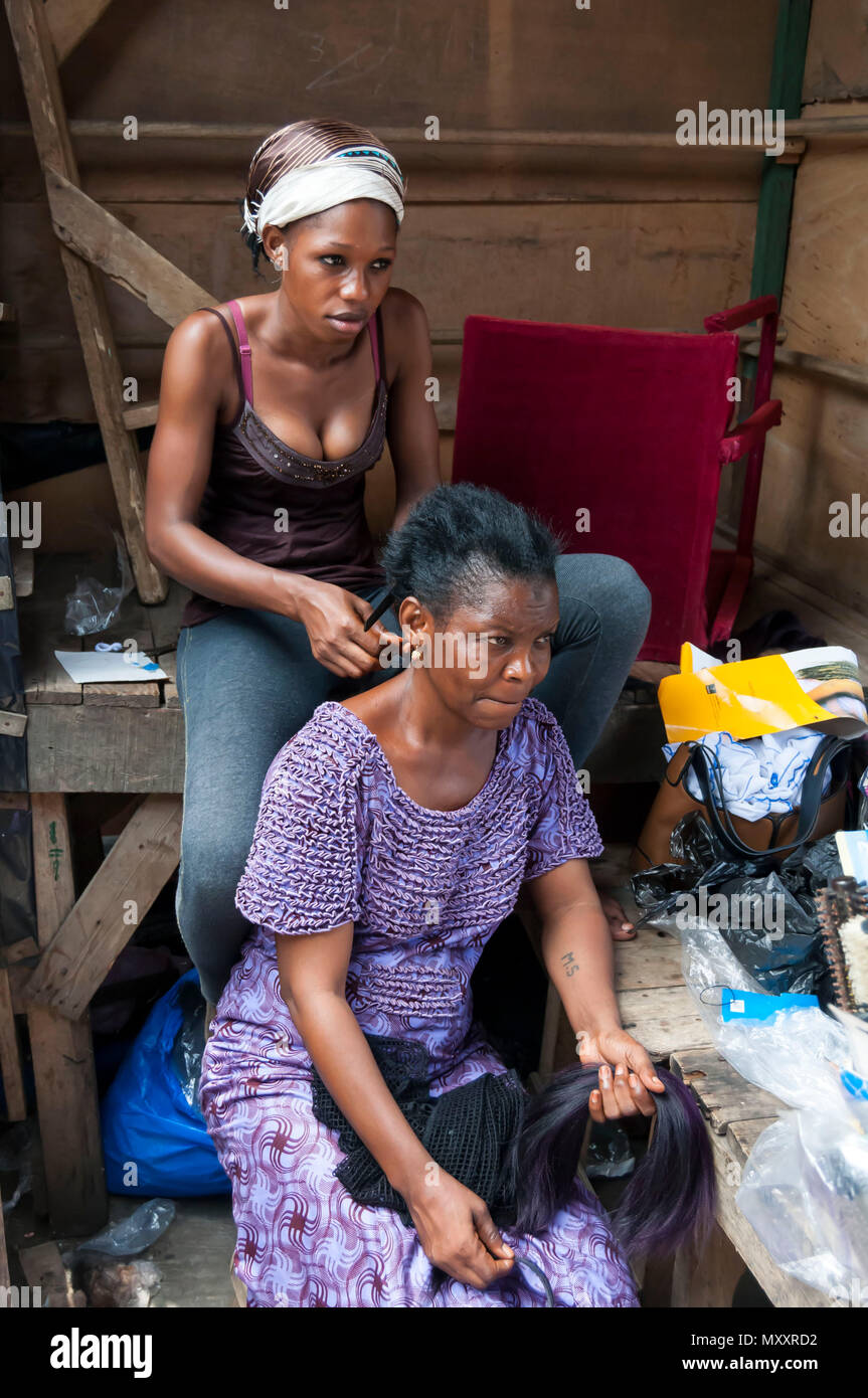 Original African hair braiding - Ivorian woman visiting a hairdresser ...