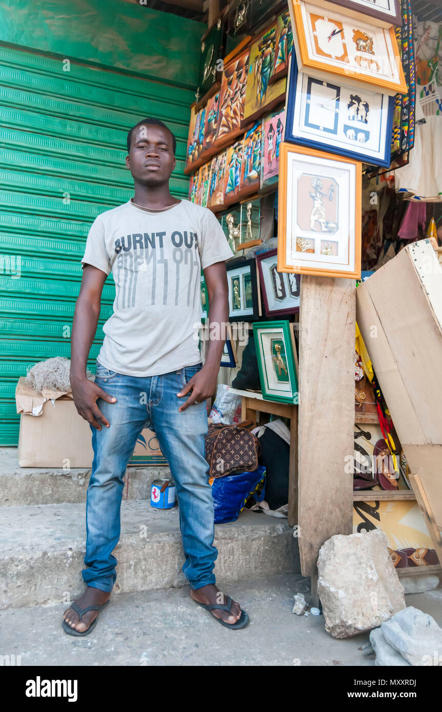 Young African male street vendor selling art pieces in the market ...