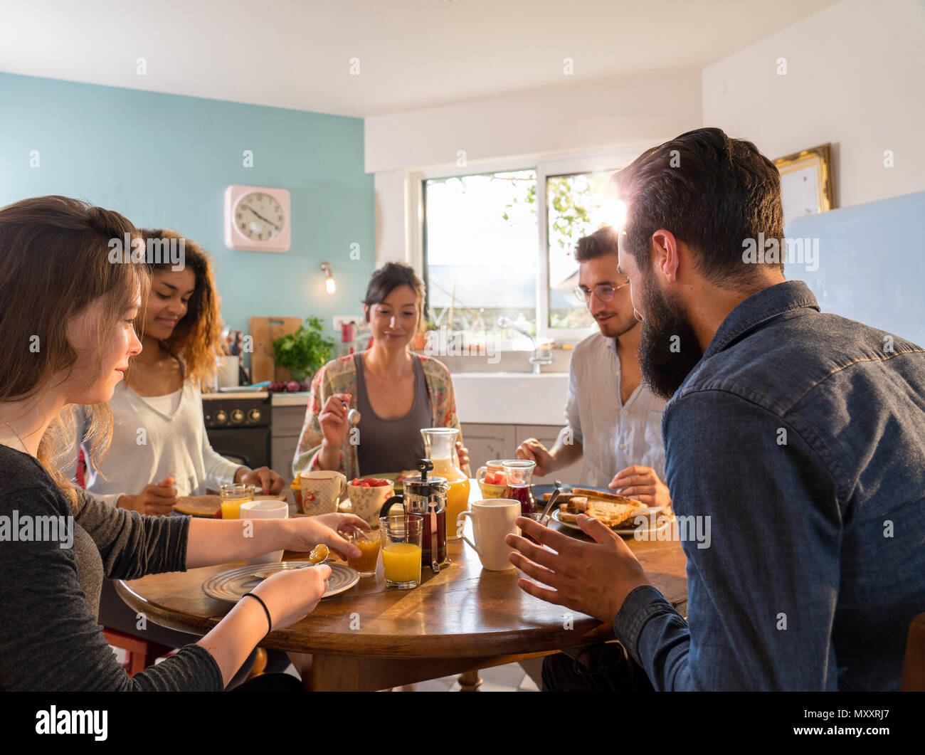 A multi ethnic group of people around a table hi-res stock photography ...