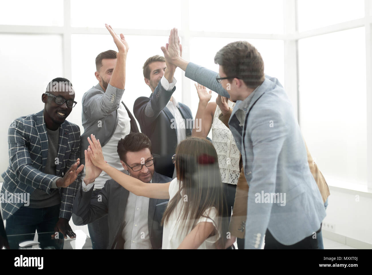 Team members high five other hi-res stock photography and images - Alamy