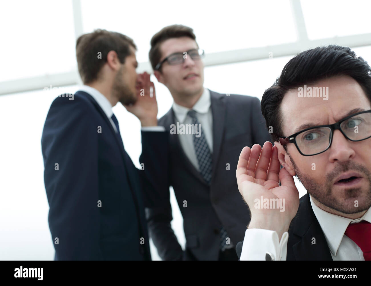 close up.businessman eavesdropping on conversation between colleagues ...