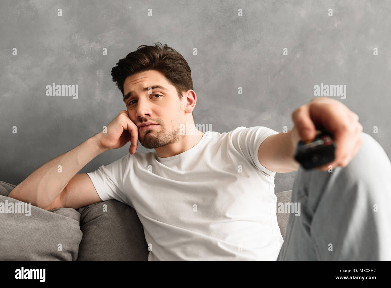 Bored guy sitting on couch hi-res stock photography and images - Alamy