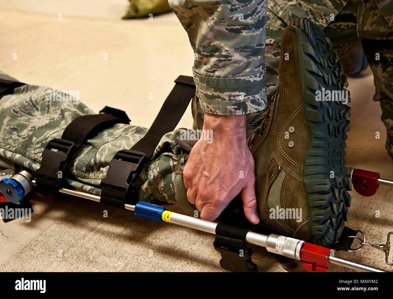 An Airman with the 5th Medical Operations Squadron applies tension on a ...
