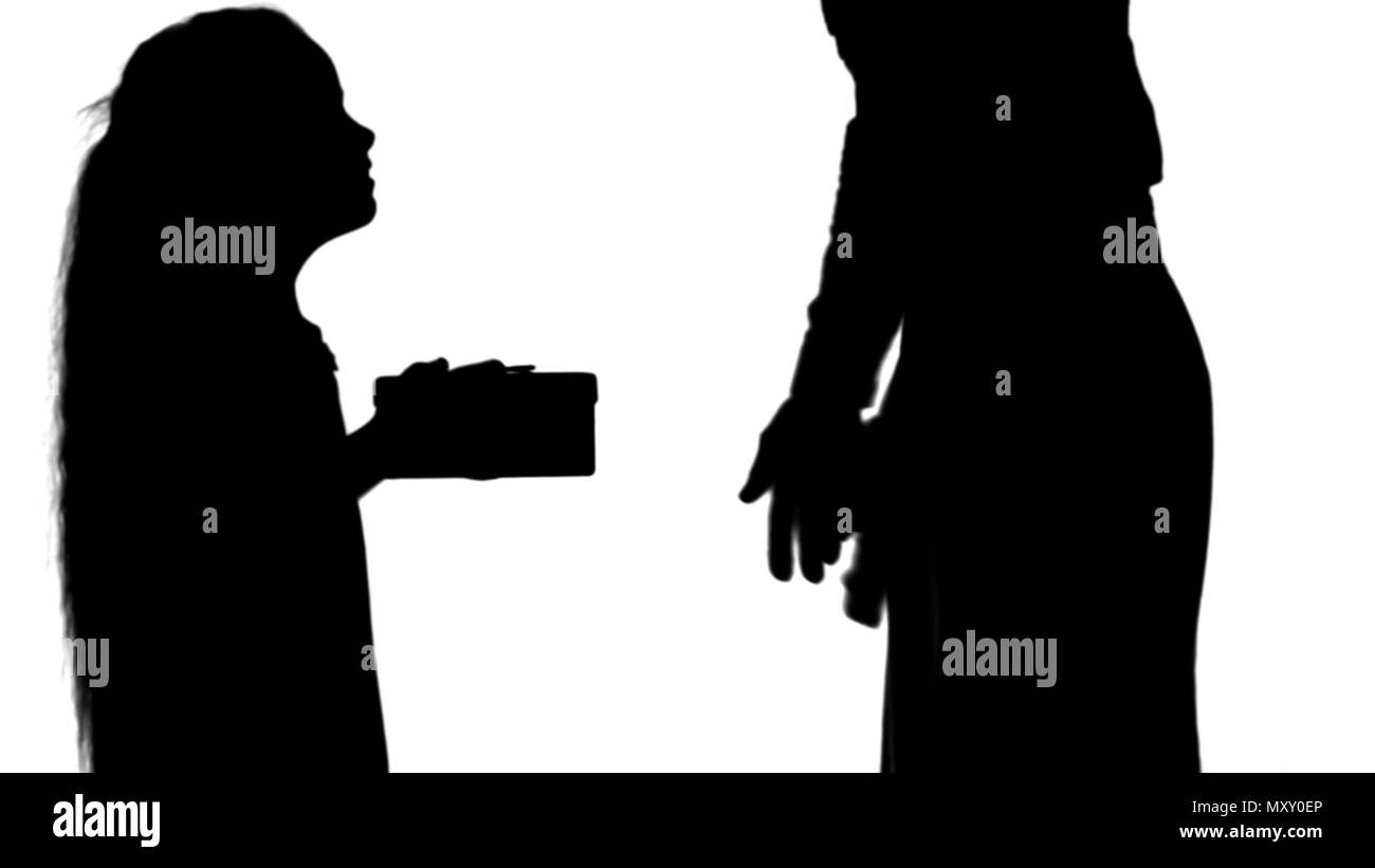 Silhouette Young charming mother and her cute daughter opened Christmas ... Silhouette Young charming mother and her cute daughter opened Christmas ...