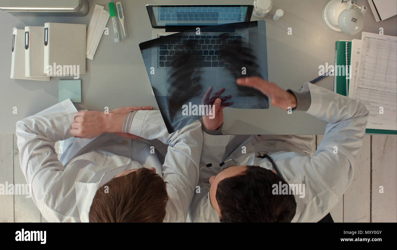 Top view of Doctors discussing intestines xray at medical office Stock ...