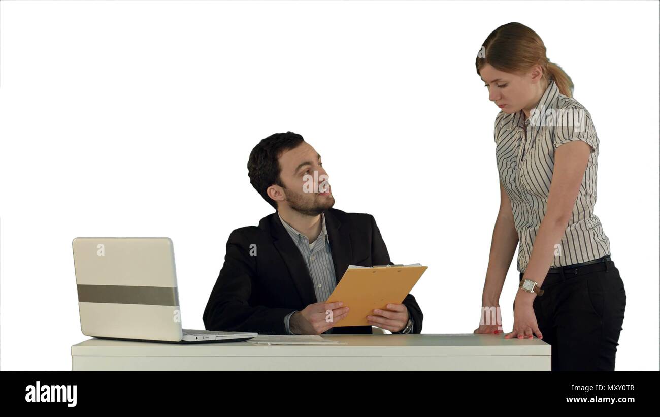 Secretary standing in the office presenting a document to her boss on ...