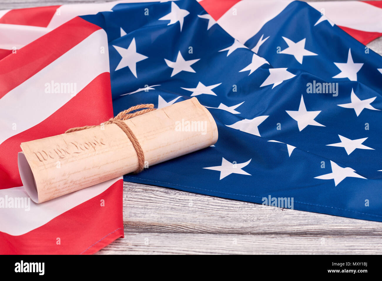 USA flag and ancient manuscript. Rolled-up constitution document on ...