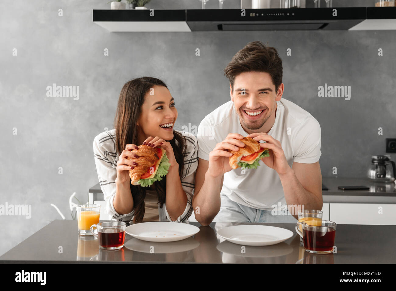 Young couple eating sandwiches hi-res stock photography and images - Alamy