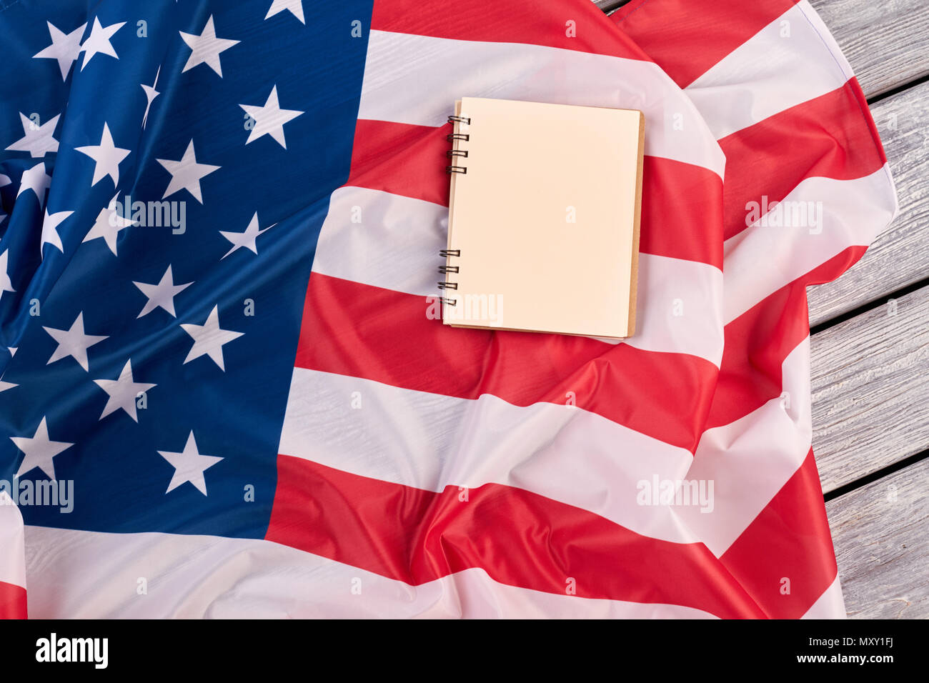Blank paper notepad on USA flag. Opened notebook and USA flag on wooden ...