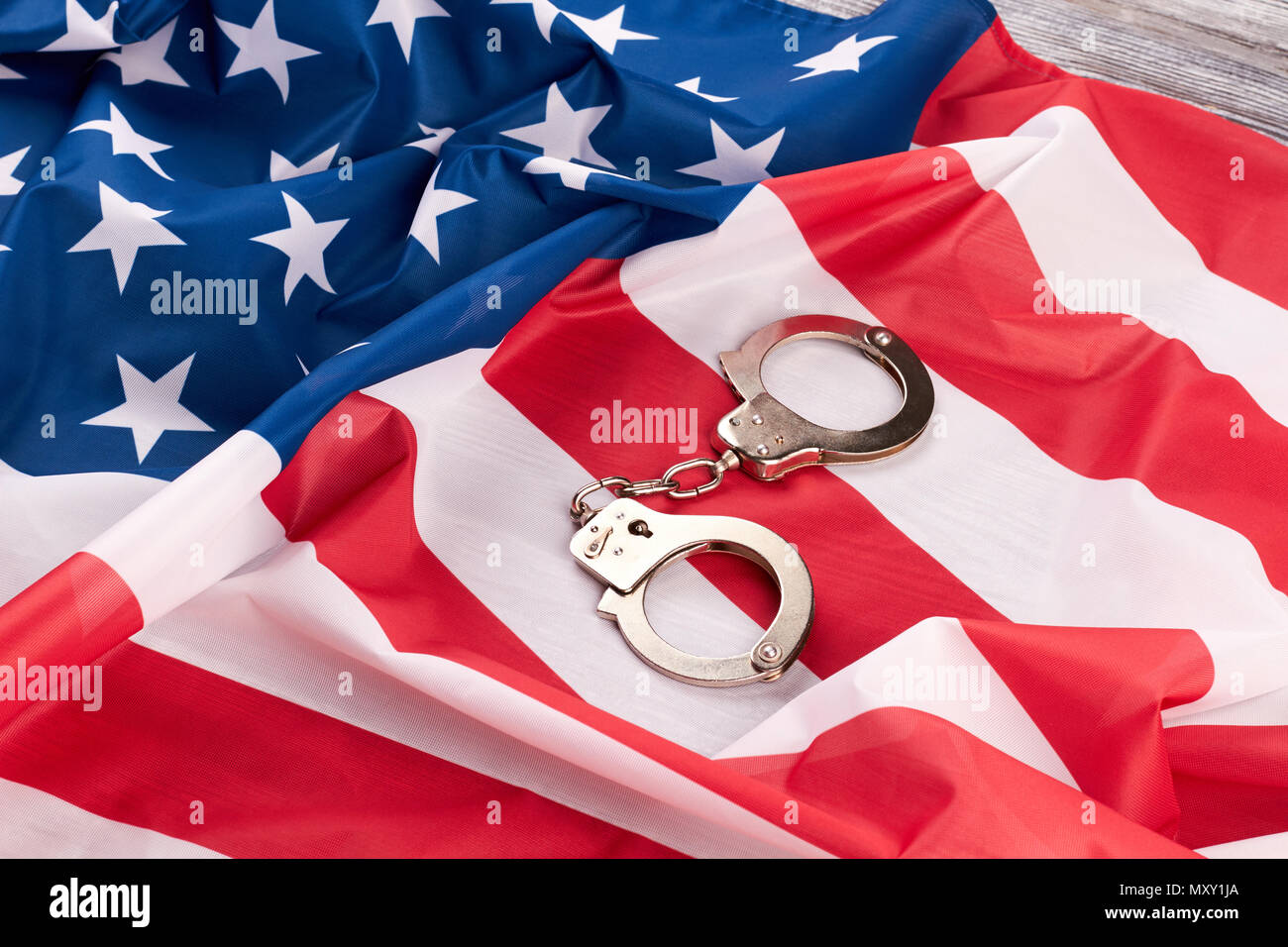 Flag of America and handcuffs. USA flag and pair of metallic handcuffs ...