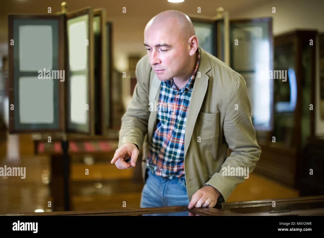 Portrait of adult male looking with interest exposition in museum of ... Portrait of adult male looking with interest exposition in museum of ...