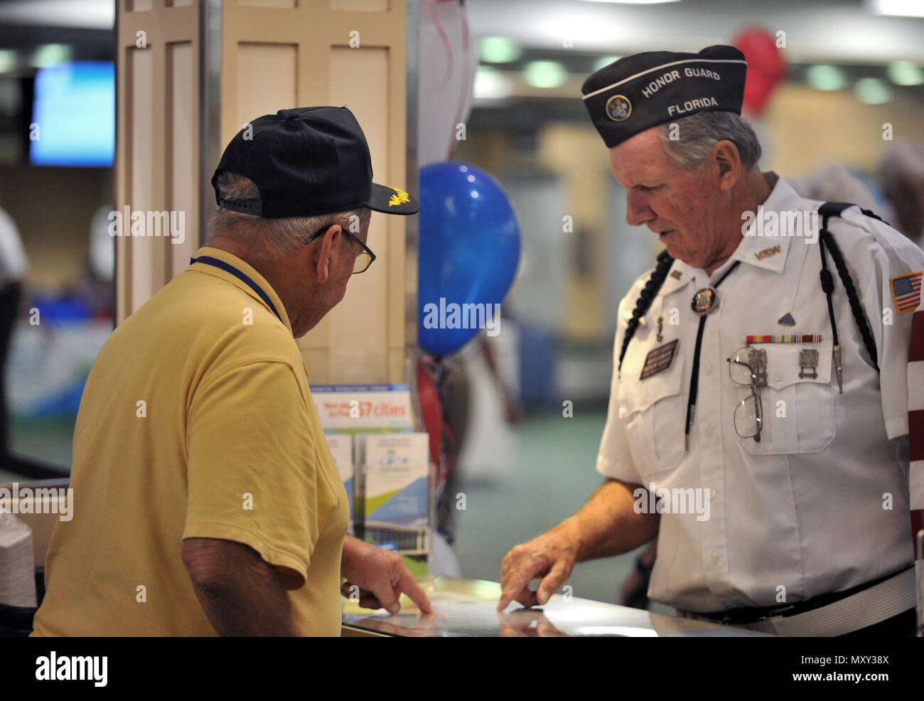 A veteran checks in with a volunteer prior to the arrival of war ...