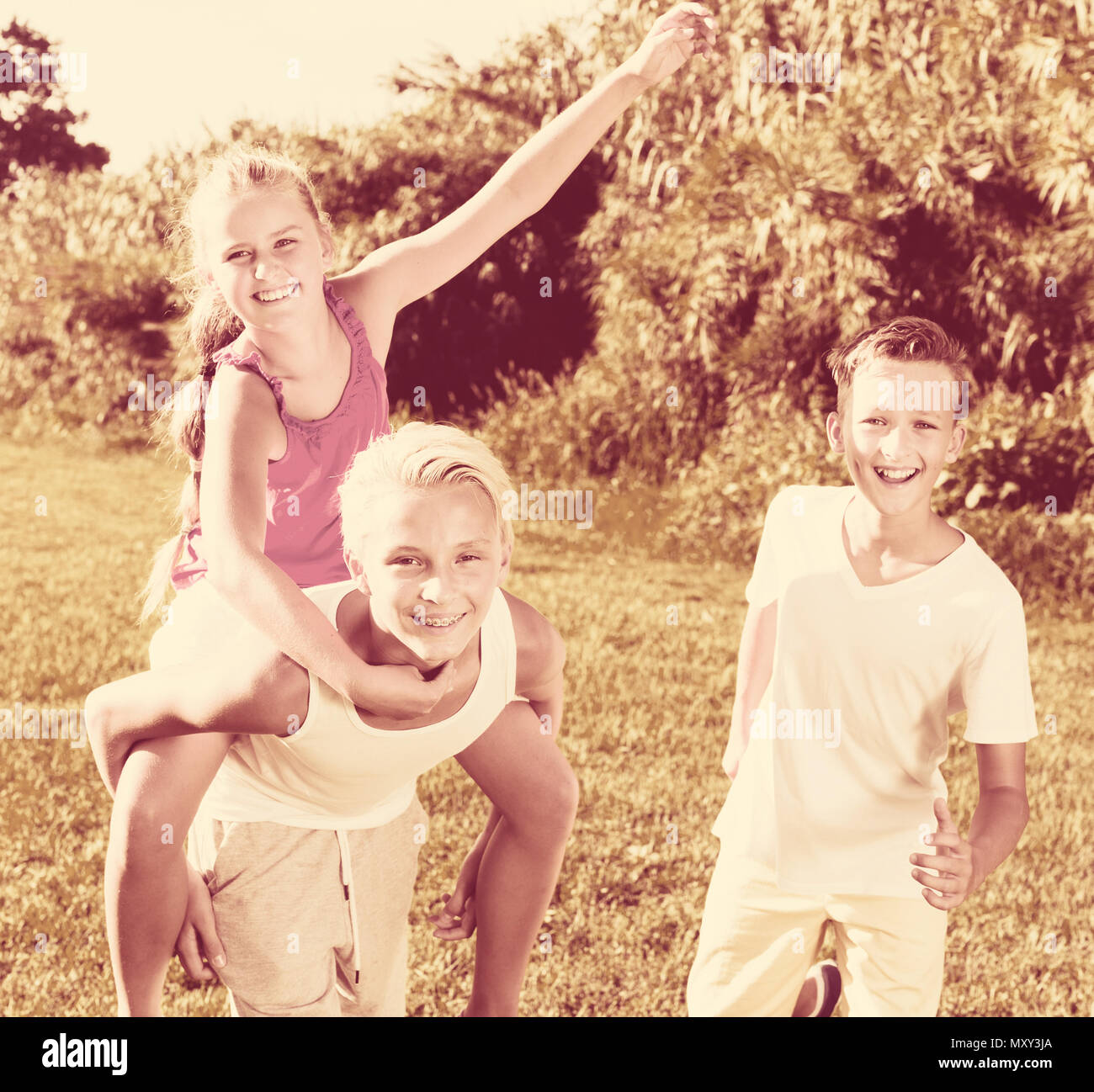 Group of laughing kids running happily together on grass Stock Photo ...