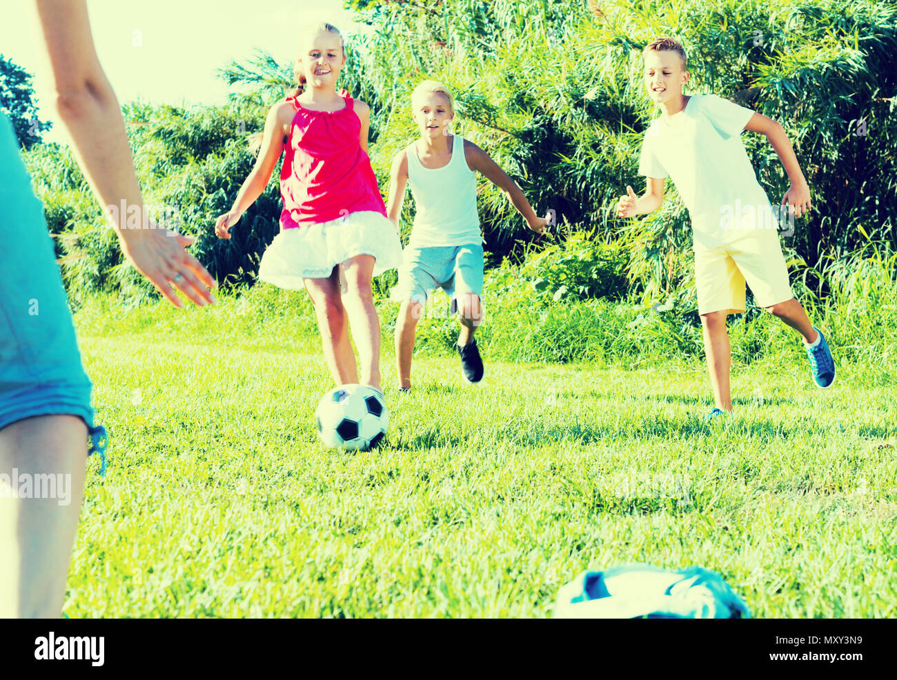 Group of happy young children having fun together outdoors playing ...