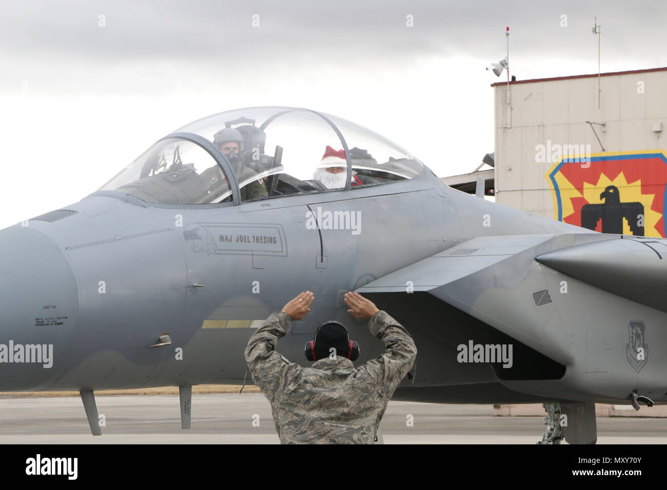 A 173rd Fighter Wing F-15 crew chief signals in the F-15 Eagle carrying ...