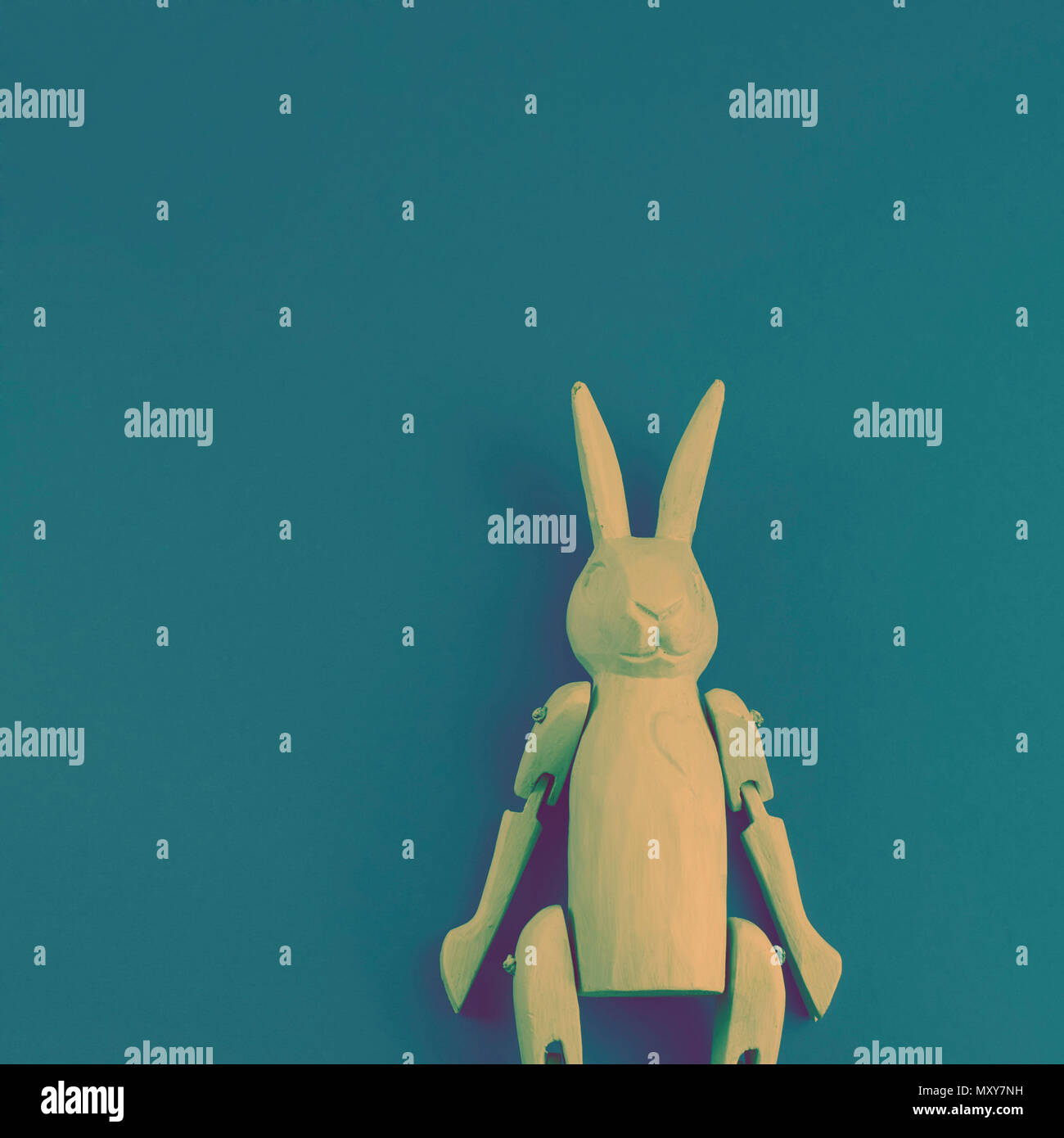 Surrealism composition vintage wooden rabbit on dark blue background ...