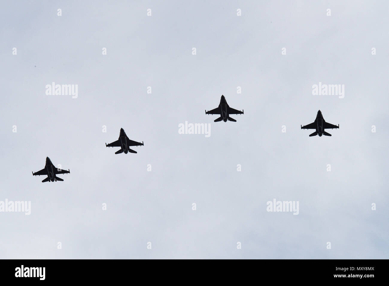 Four F-16 Fighting Falcons fly in formation over the funeral service ...