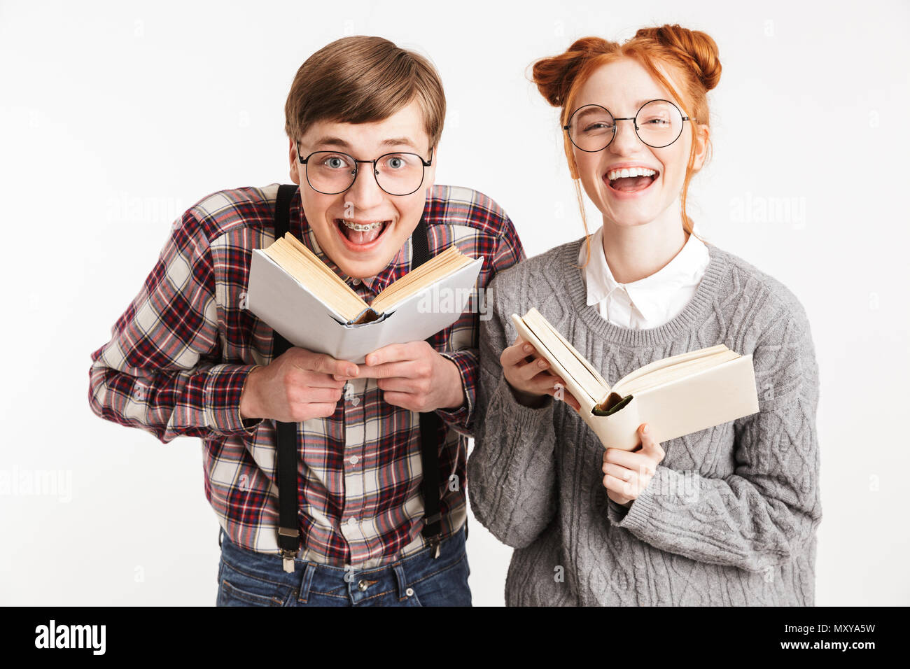 Laughing couple of school nerds holding books isolated over white ...