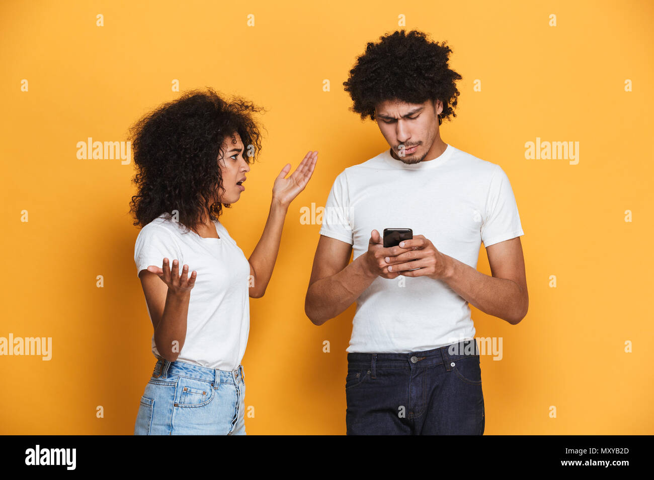 Portrait of a frustrated young afro american couple having an argument ...