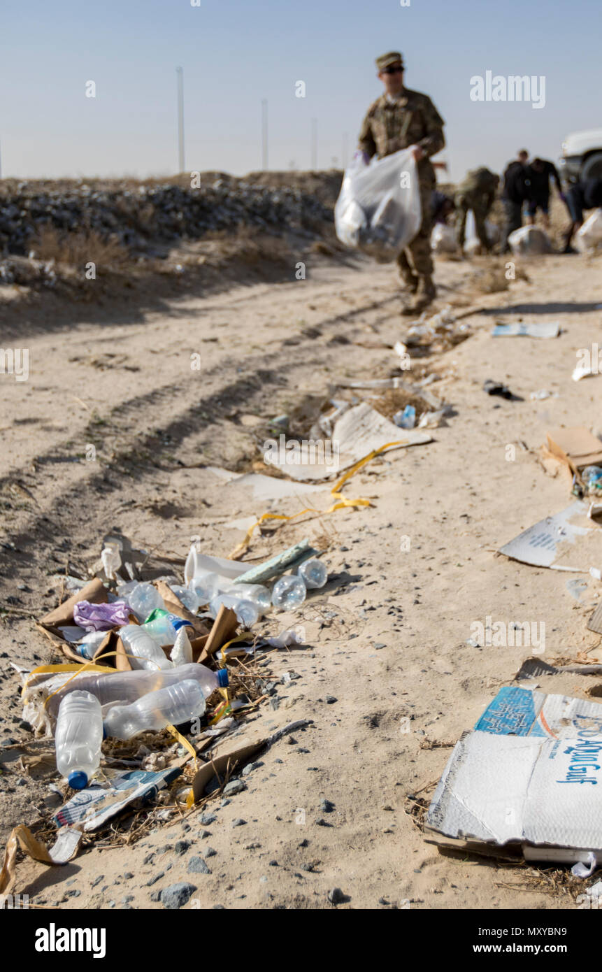 Volunteers pick up trash during an organized cleanup, Operation Flying ...