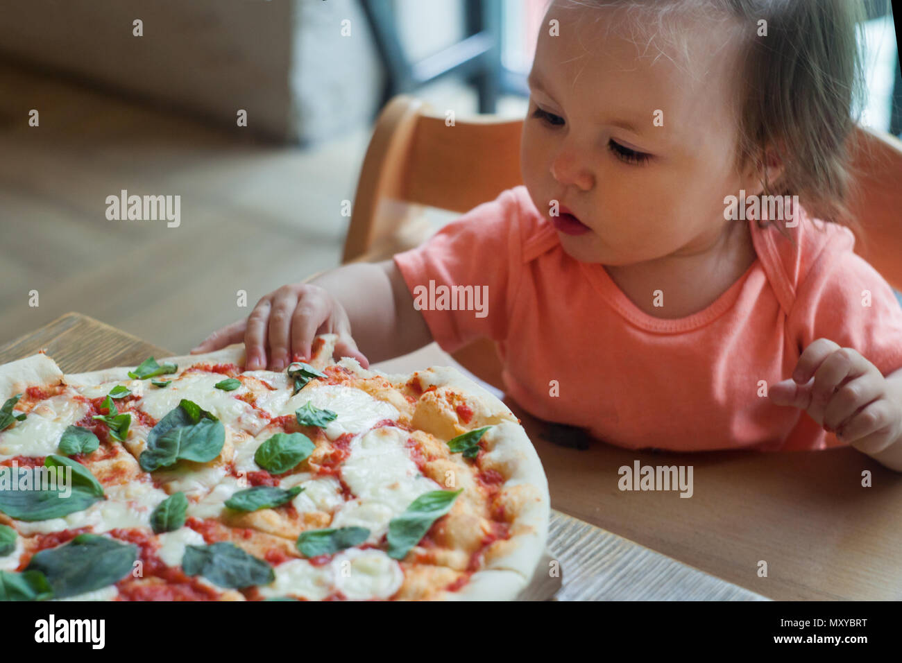 baby girl eating pizza in italian restaurant, Healthy, unhealthy food ...