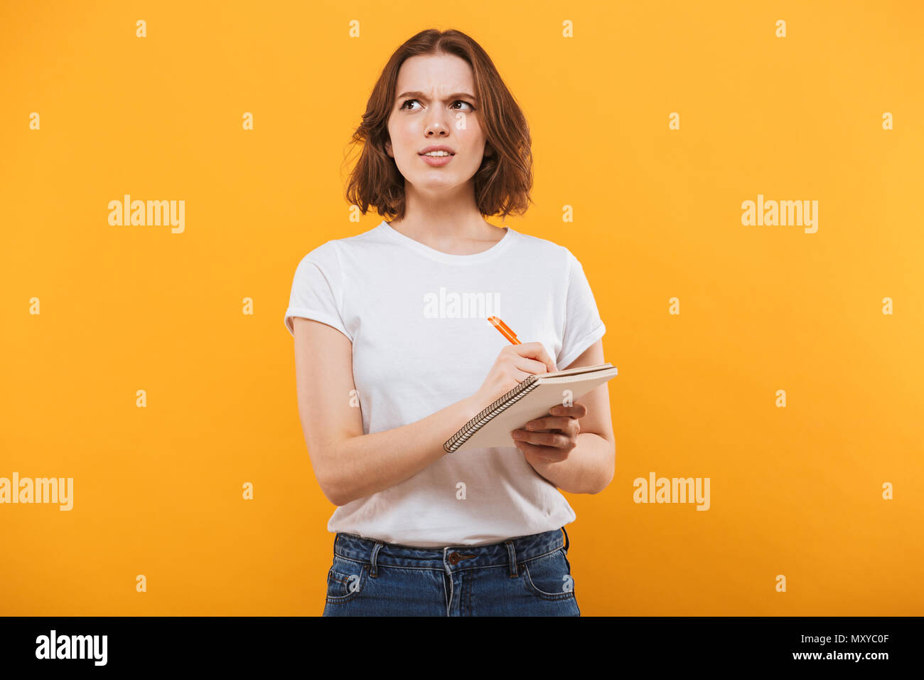 Image of confused thinking young woman standing isolated over yellow ...